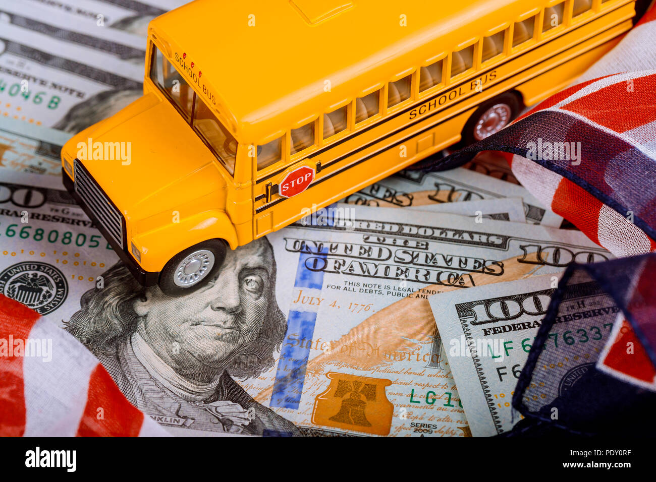 toy yellow school bus , US flag and dollar cash money Stock Photo - Alamy