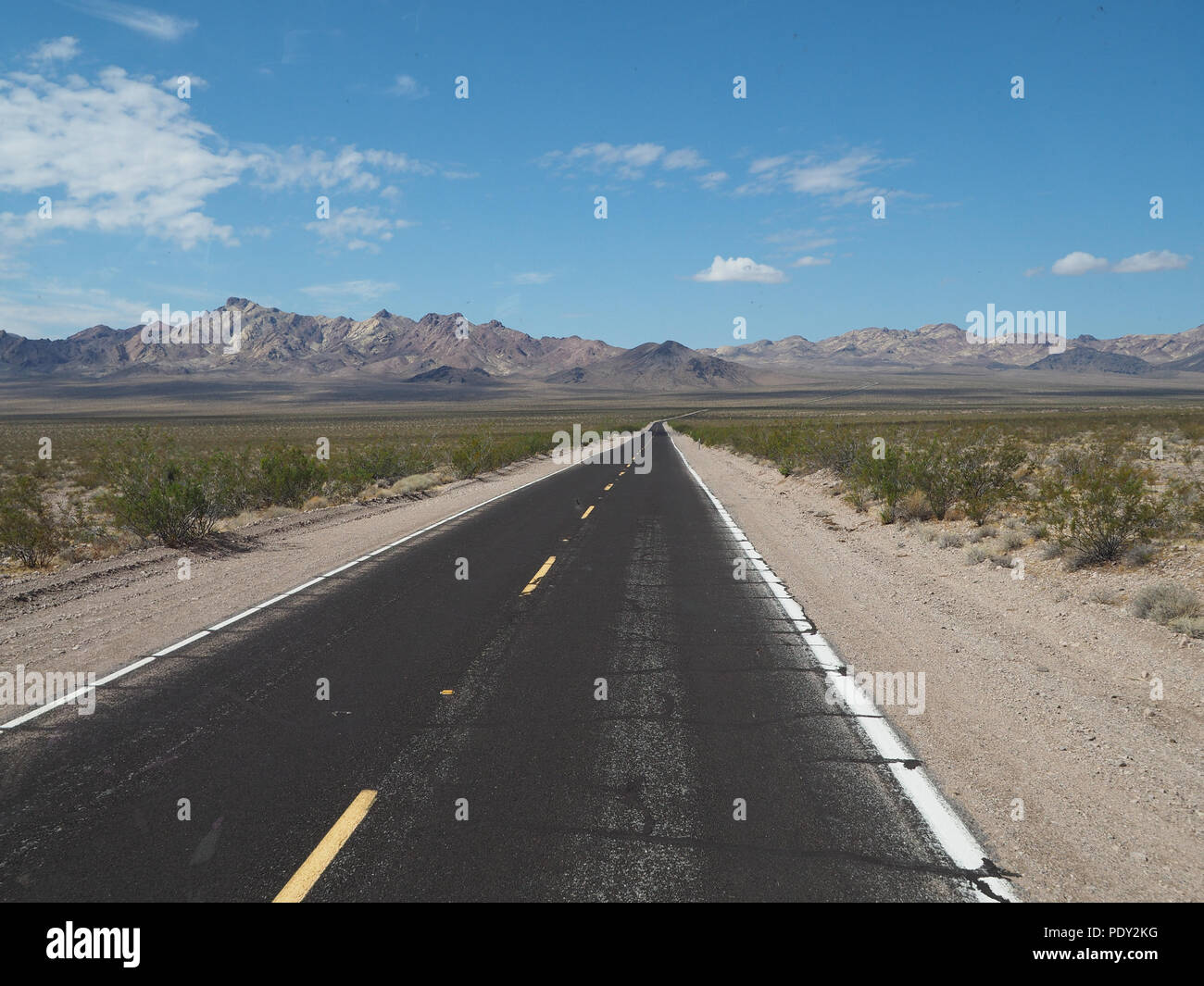 Lonely long road through desert landscape, Highway 190, Death Valley ...