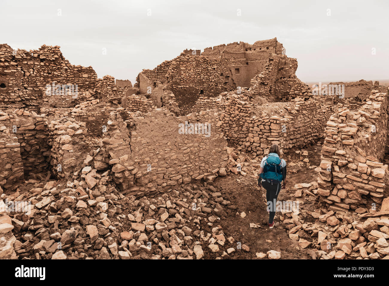 Tourist explores a dilapidated city, ruins, Ksar Meski, Errachidia ...
