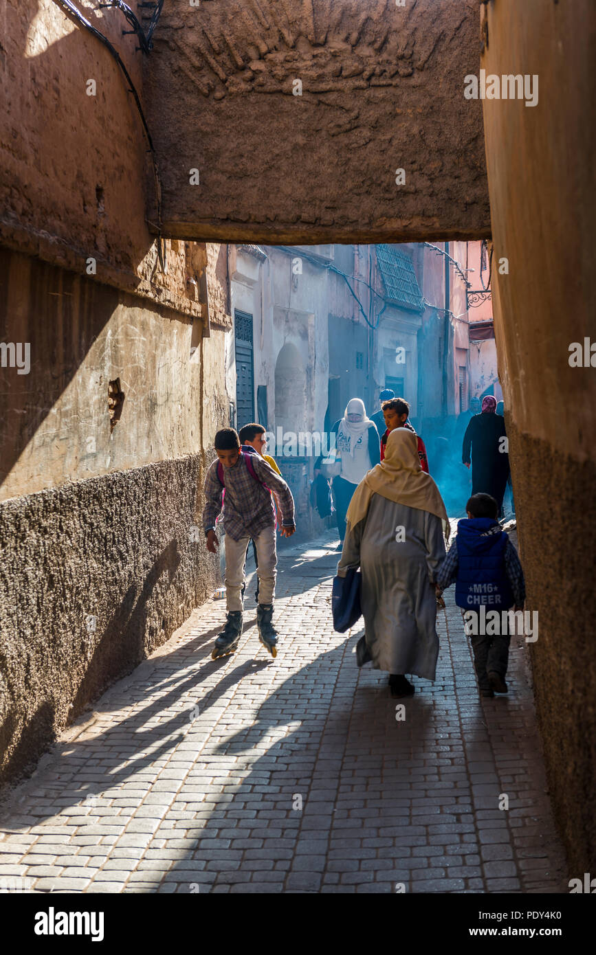 Locals in a narrow alley between houses, backlight, alleyway scene, Fez ...