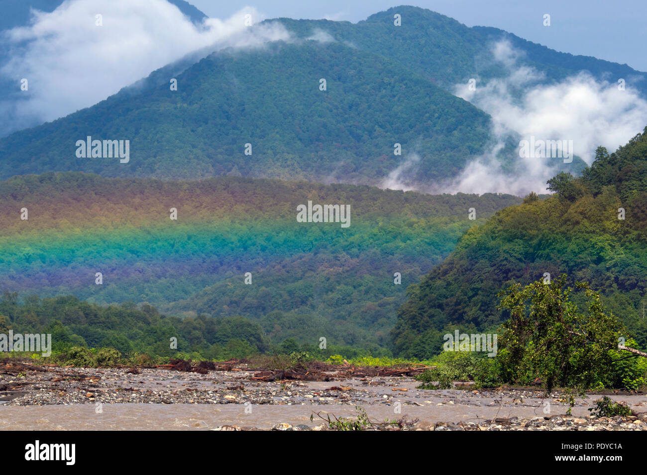 Mountain landscape with a rainbow over river Stock Photo - Alamy