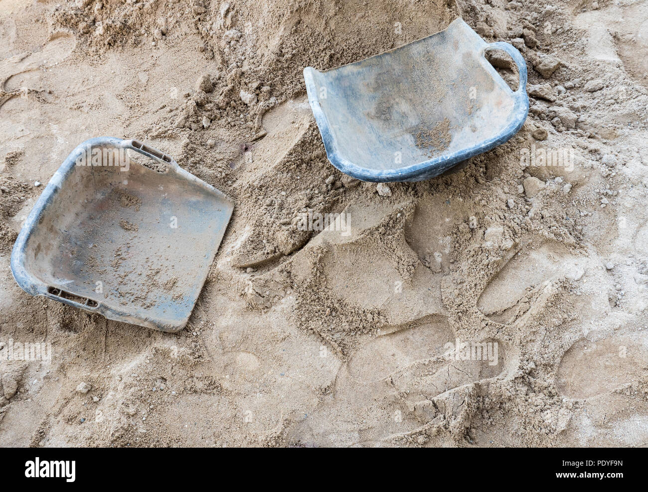 Dirty clam-shell shaped basket on the pile of sand for use in the ...