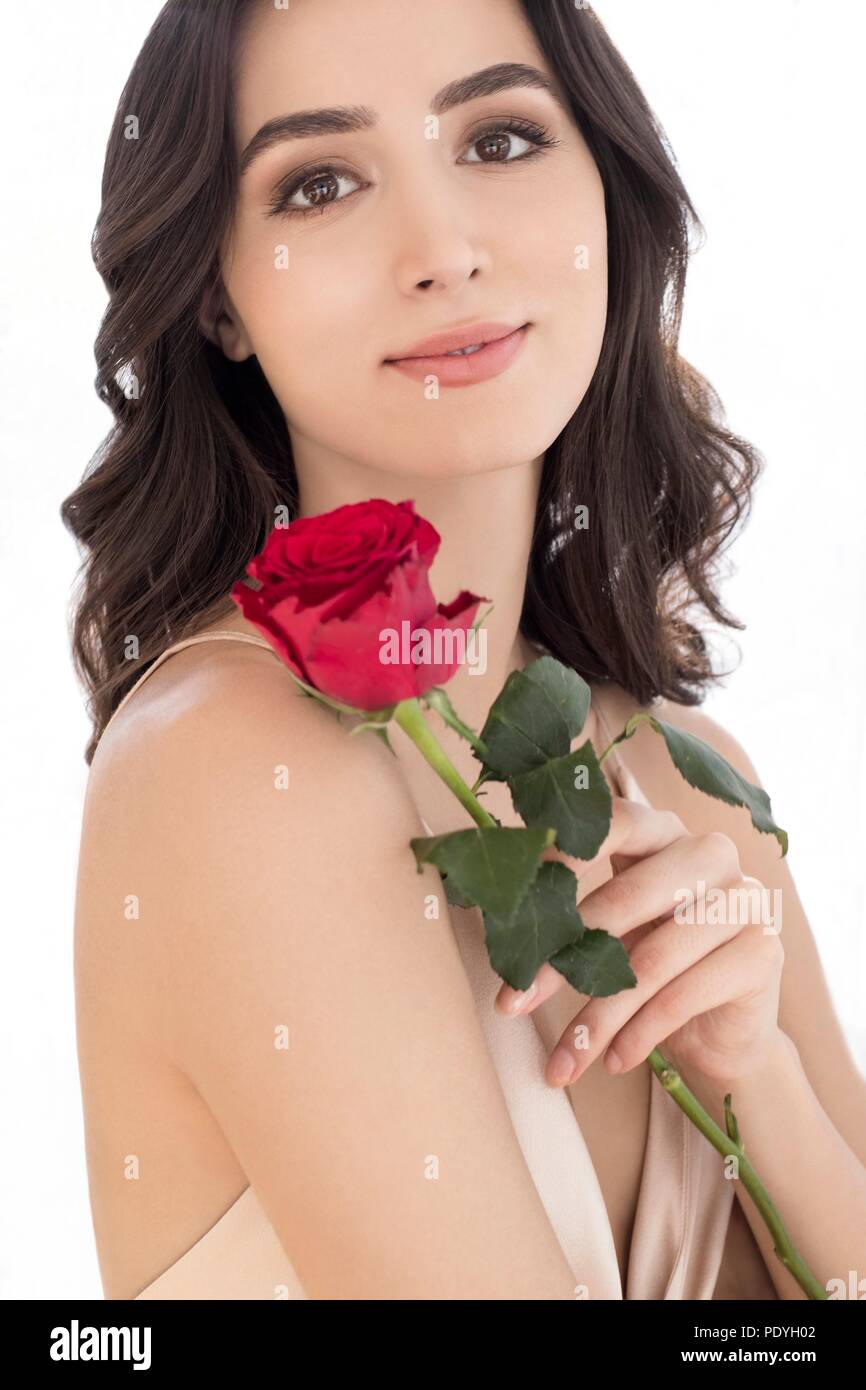 Young woman holding red rose, portrait Stock Photo - Alamy