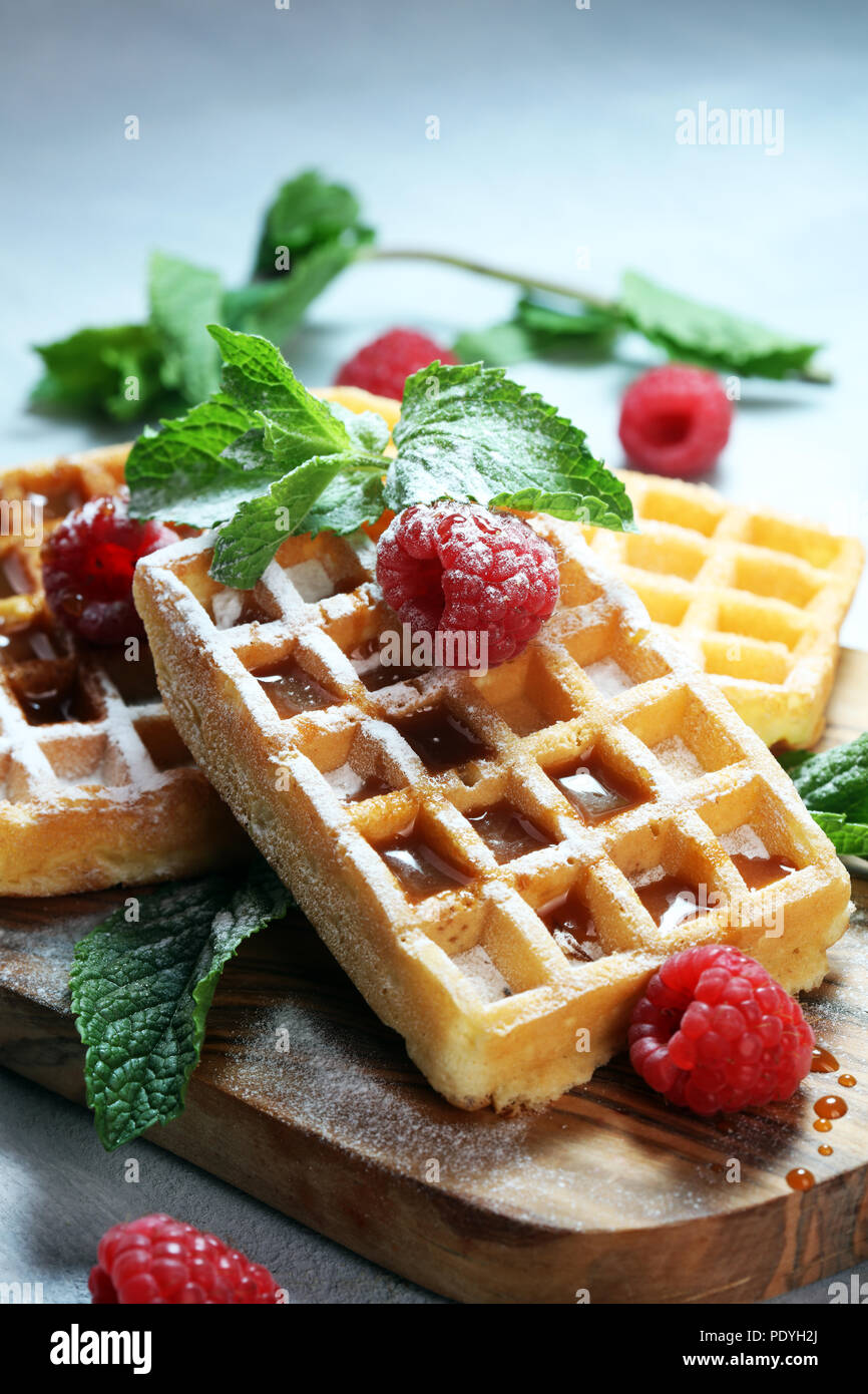Traditional belgian waffles with fresh mint, sugar and raspberries ...