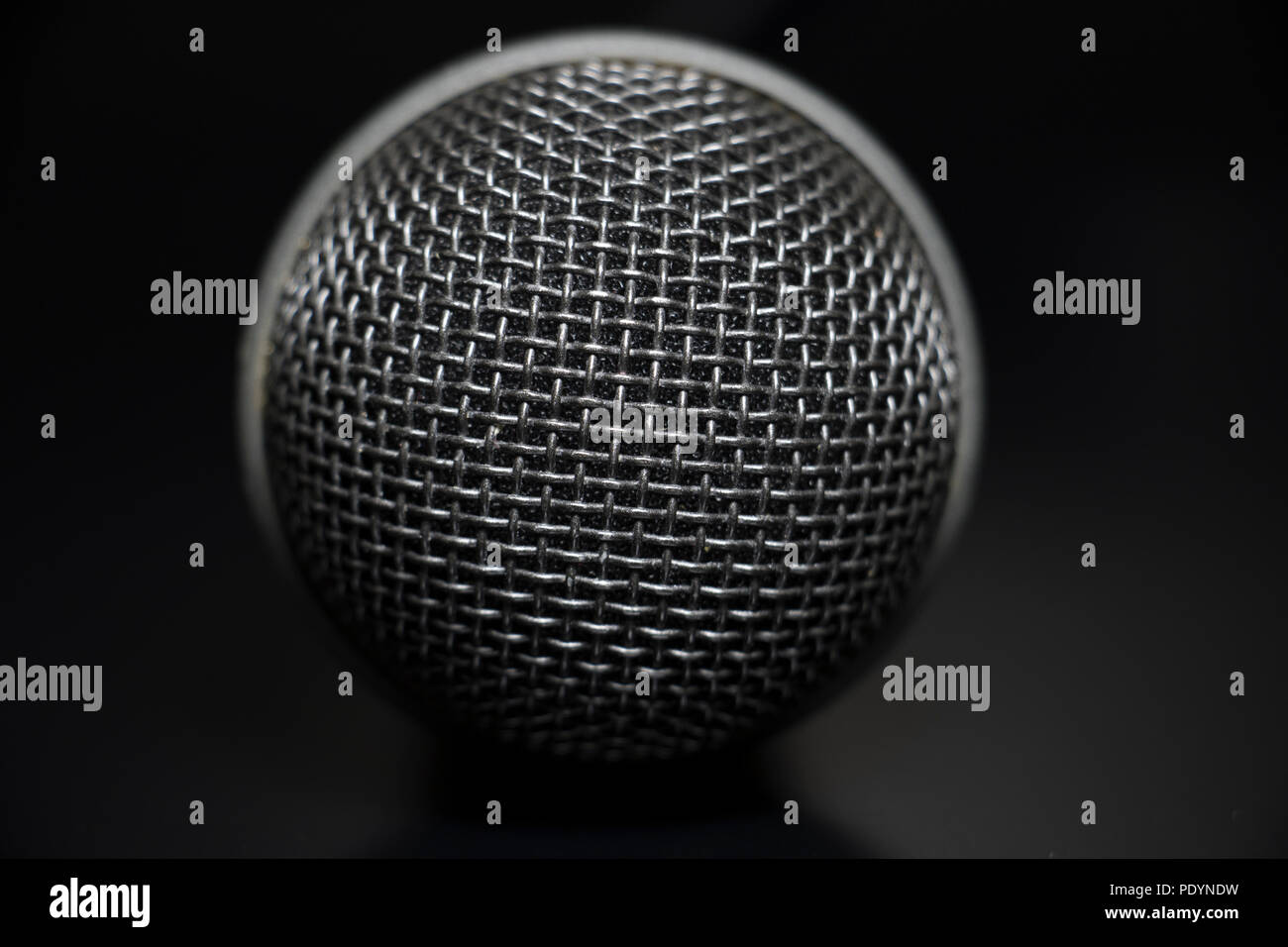 Microphone close up. Grid texture of a microphone with black background ...
