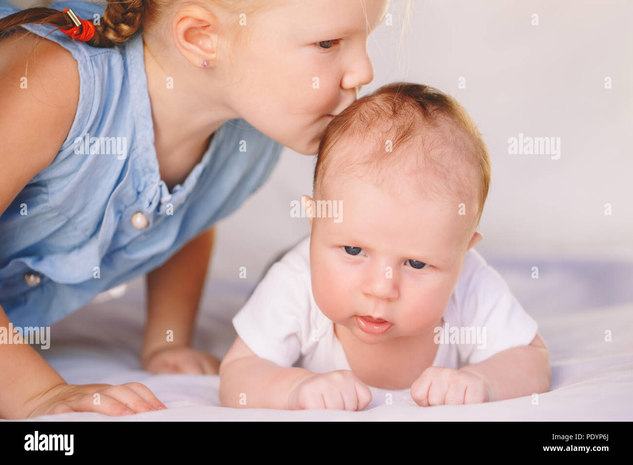 Older brother kissing sister hi-res stock photography and images - Alamy