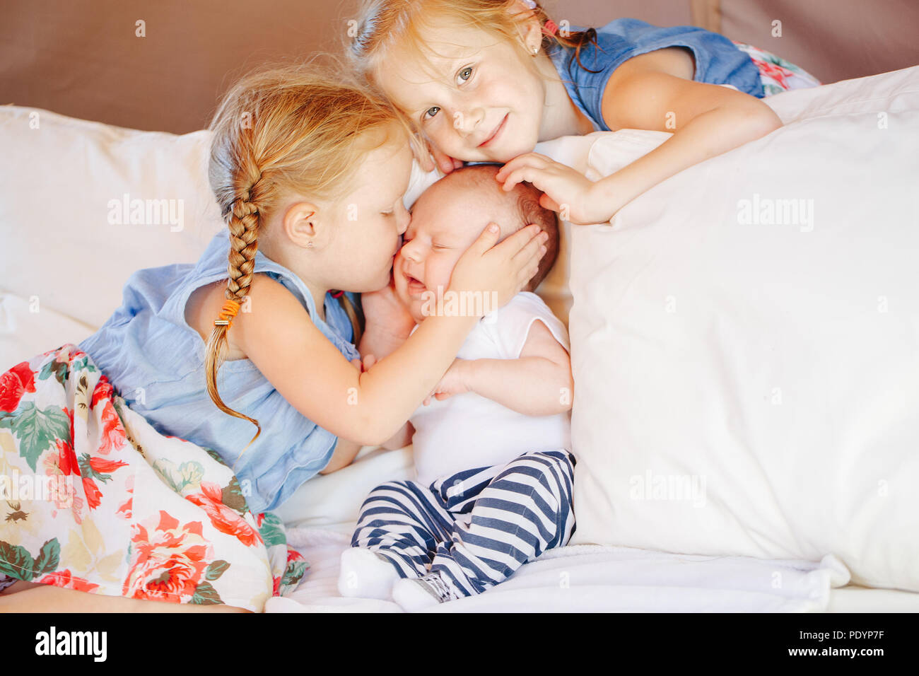 Lifestyle portrait of cute white Caucasian girls sisters holding ...