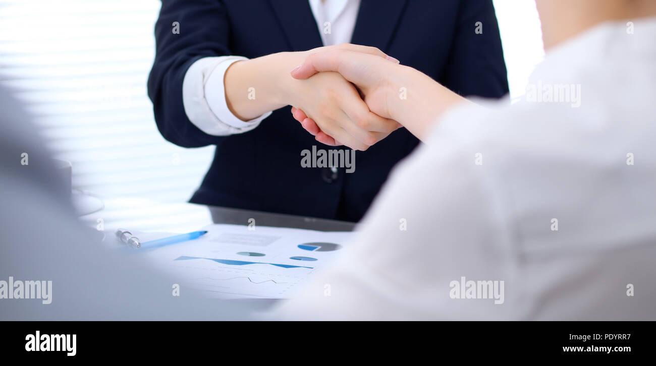 Group of business people shaking hands while finishing up a meeting ...