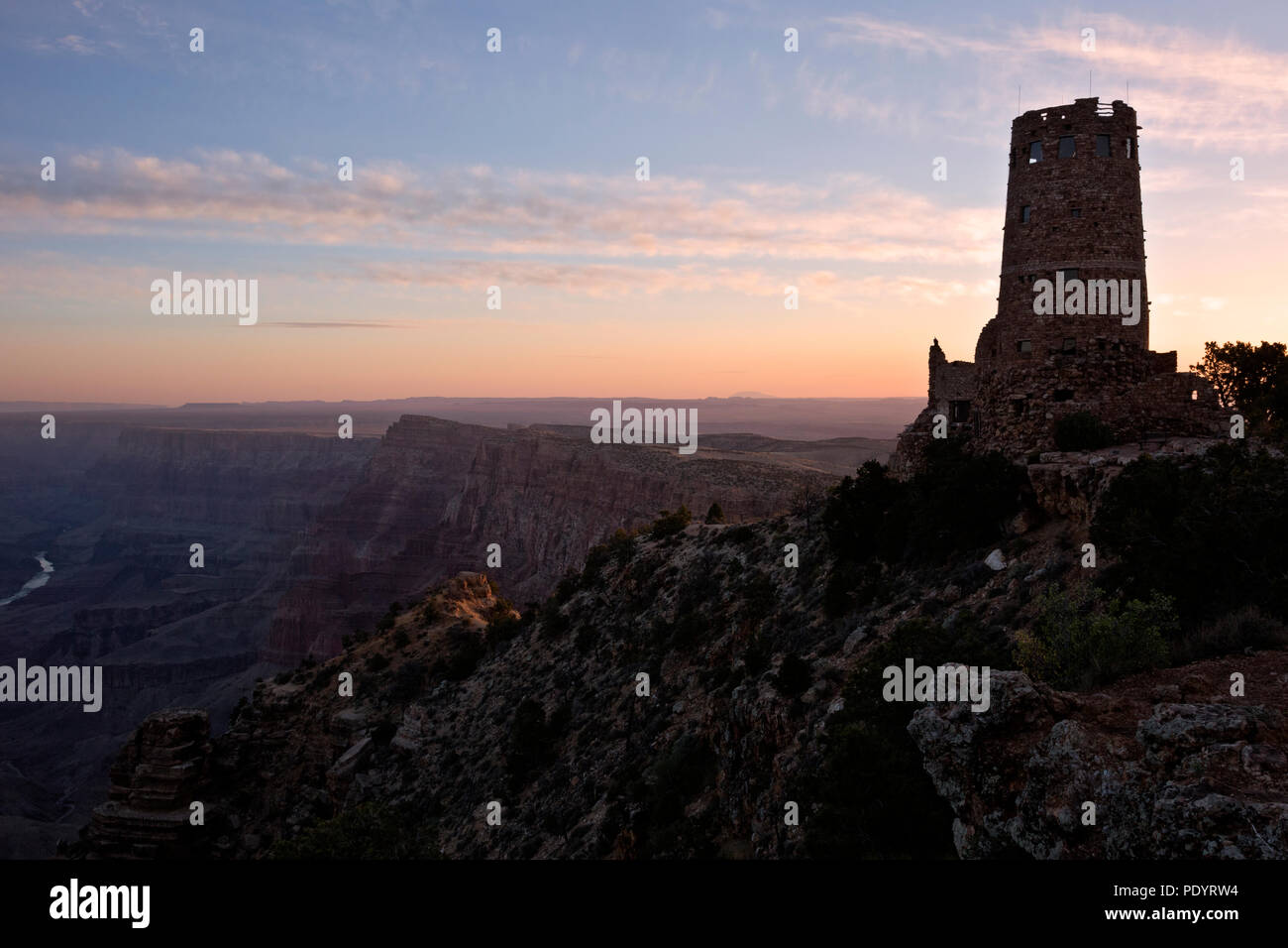 AZ00255-00...ARIZONA - Sun rising behind the Watchtower at Desert View ...
