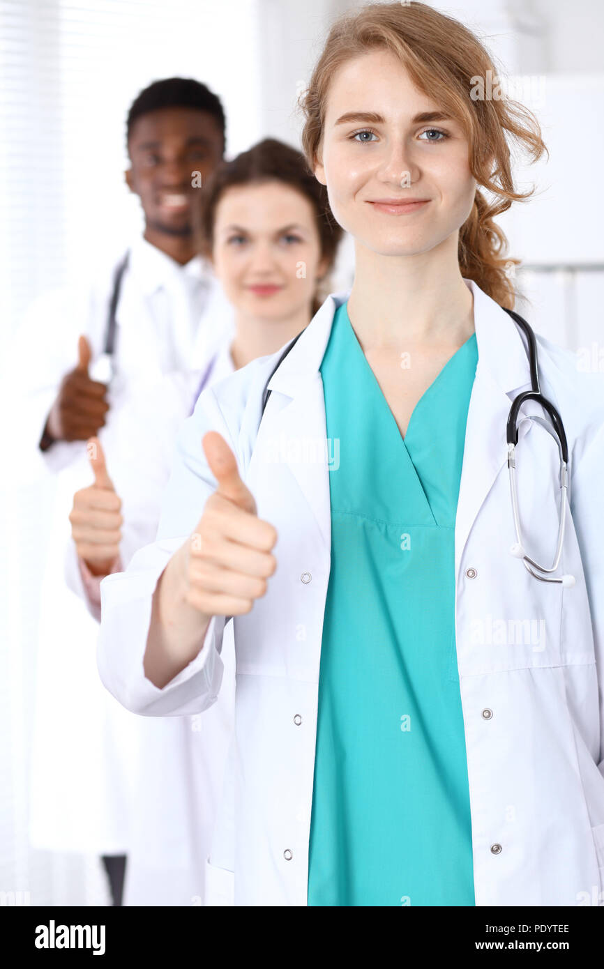 Medical team of confident doctors showing Ok sign with thumbs up ...