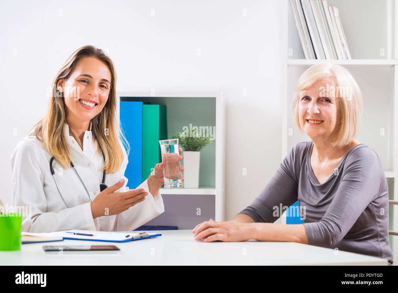 Female doctor is giving advice how is important to drink a lot of water ...