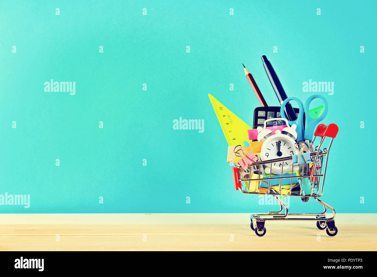 Shopping cart with stationery objects. Office and school supplies Stock ...