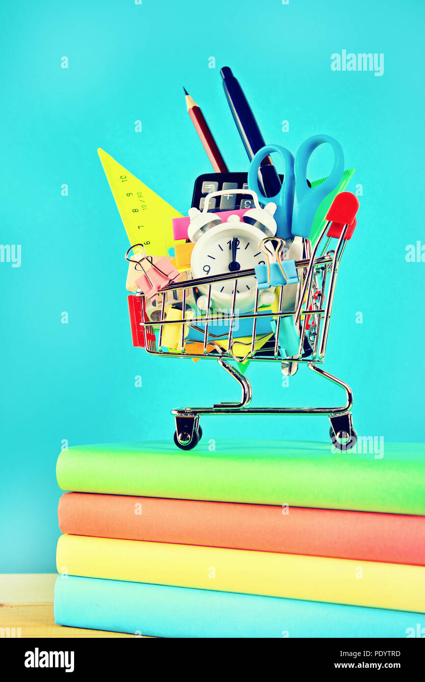 Shopping cart with stationery objects. Office and school supplies Stock ...