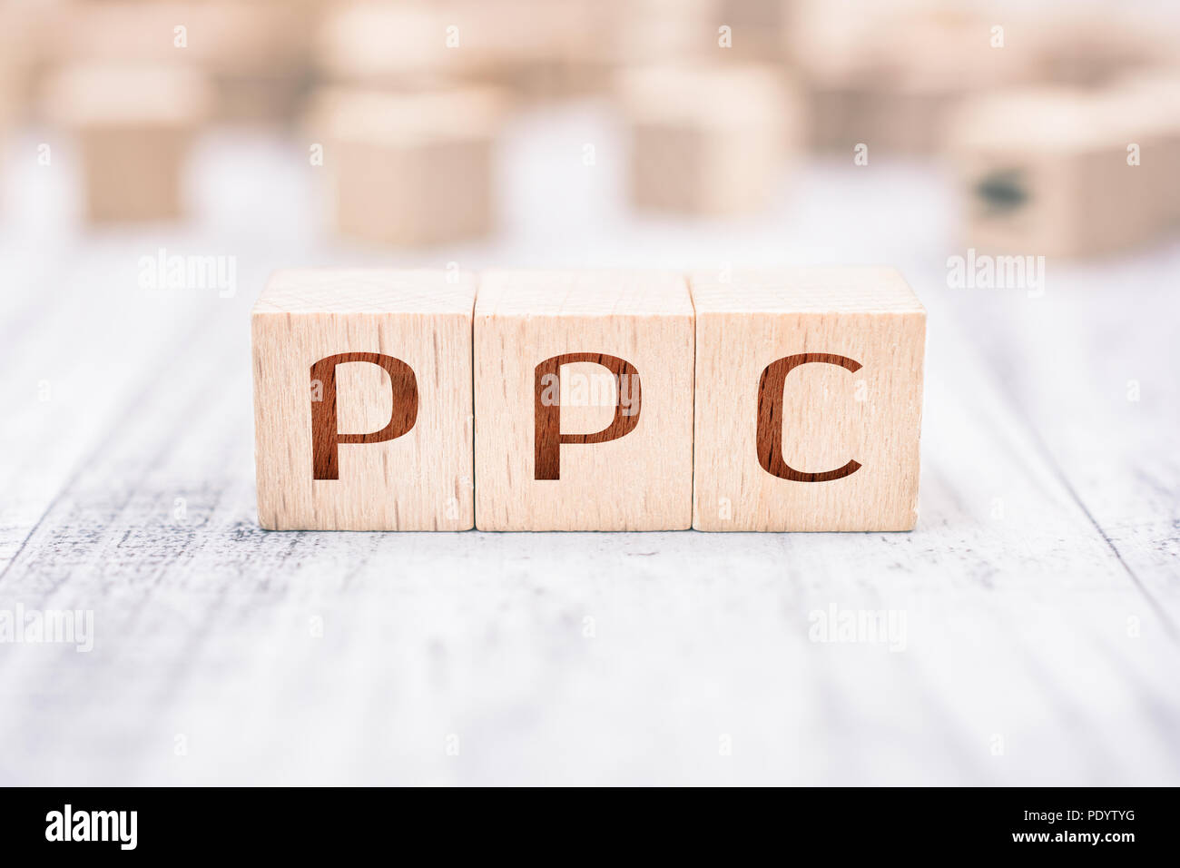 The Word PPC Formed By Wooden Blocks On A White Table Stock Photo - Alamy