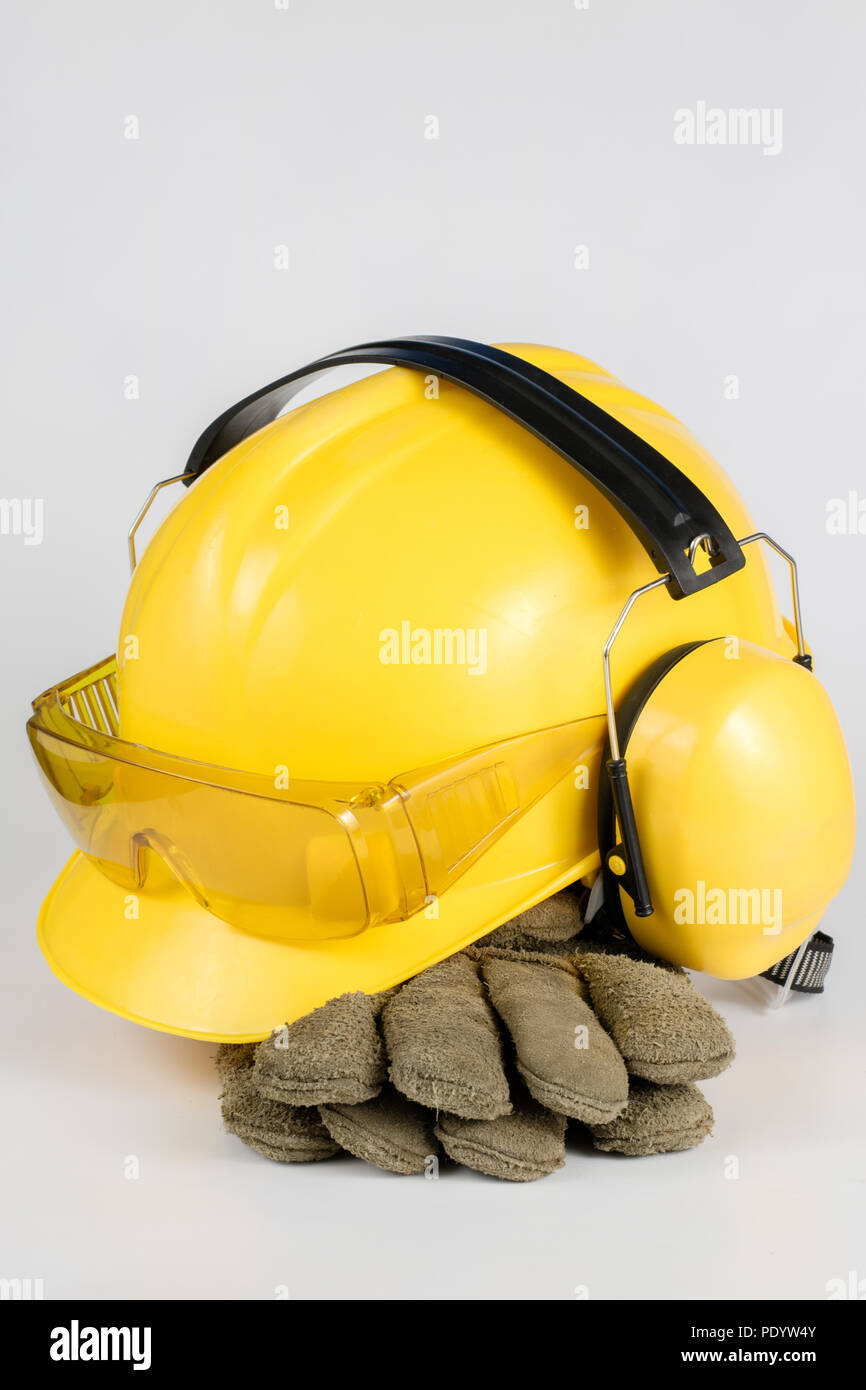 Helmet and hearing protection on a white table. Safety and hygiene ...