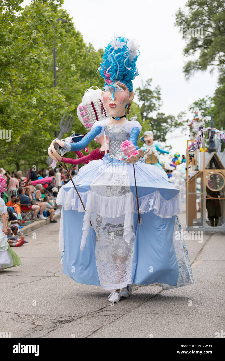 Cleveland, Ohio, USA - June 9, 2018 woman carries a large puppet on her ...