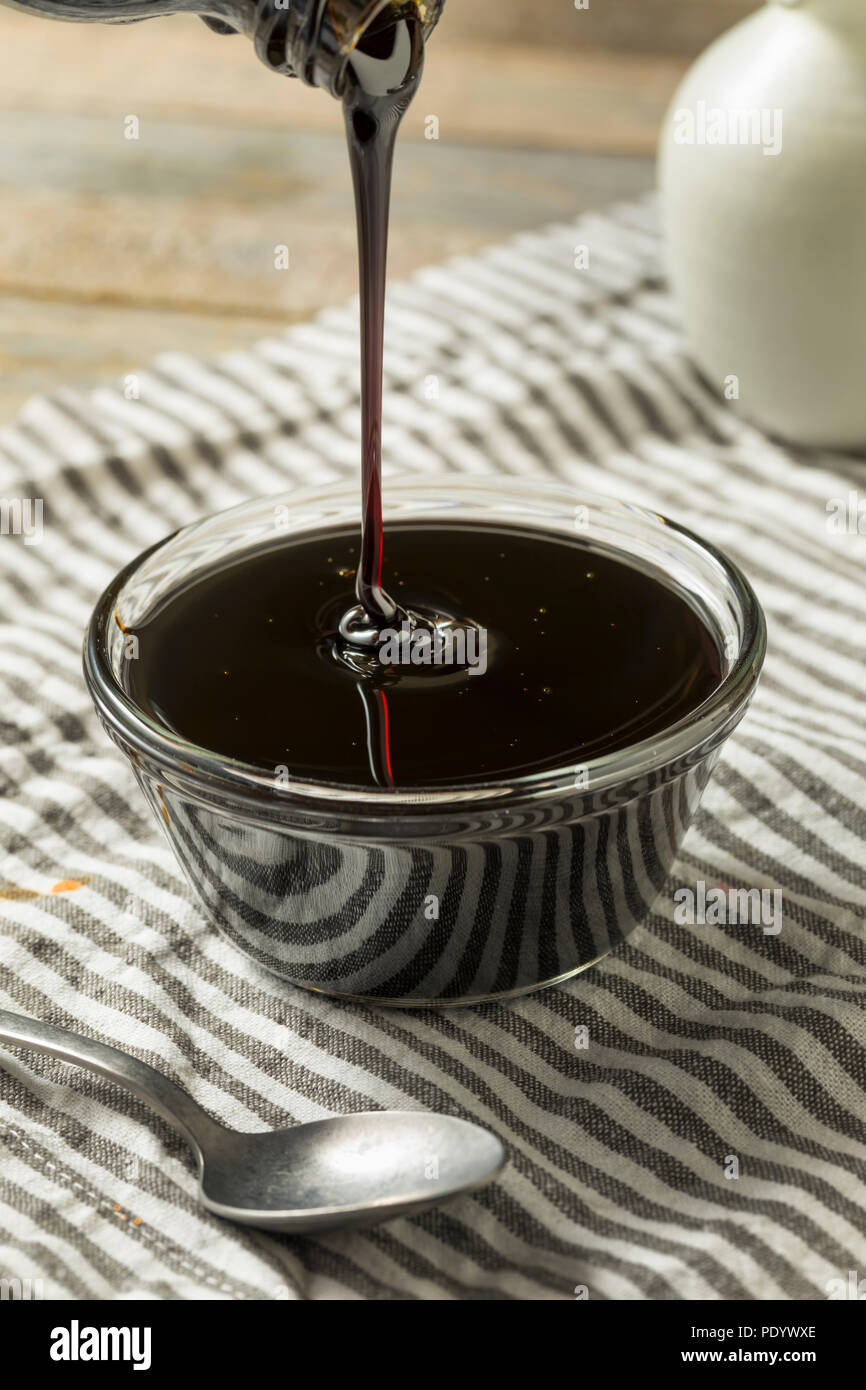 Organic Black Cane Sugar Molasses in a Bowl Stock Photo - Alamy