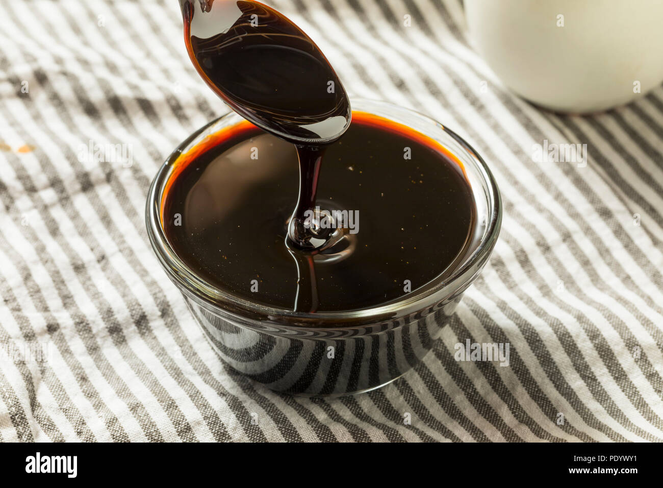 Organic Black Cane Sugar Molasses in a Bowl Stock Photo - Alamy