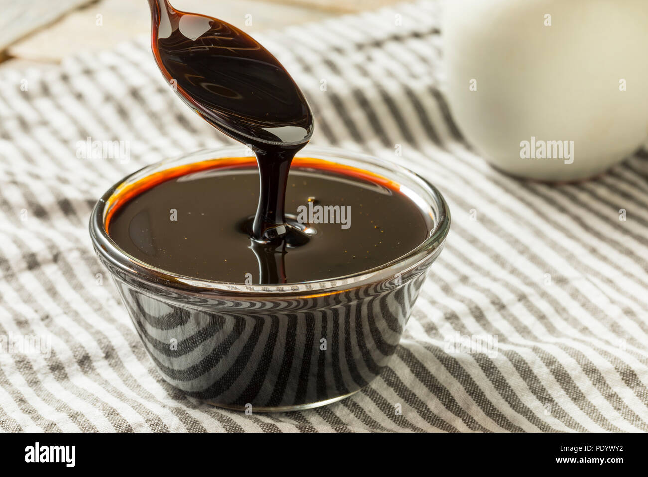 Organic Black Cane Sugar Molasses in a Bowl Stock Photo - Alamy