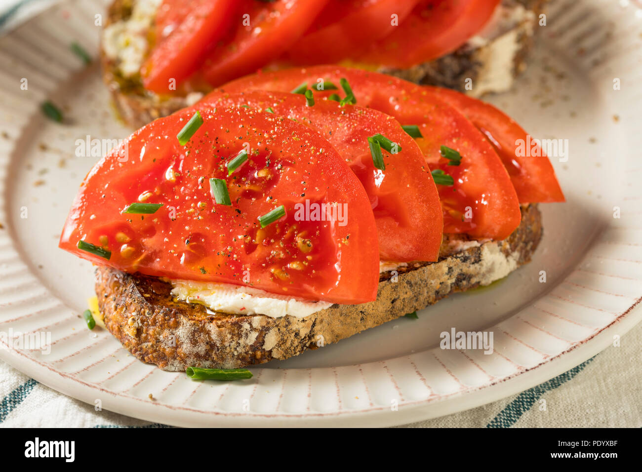 Trendy Homemade Tomato Toast with Goat Cheese and Chives Stock Photo ...