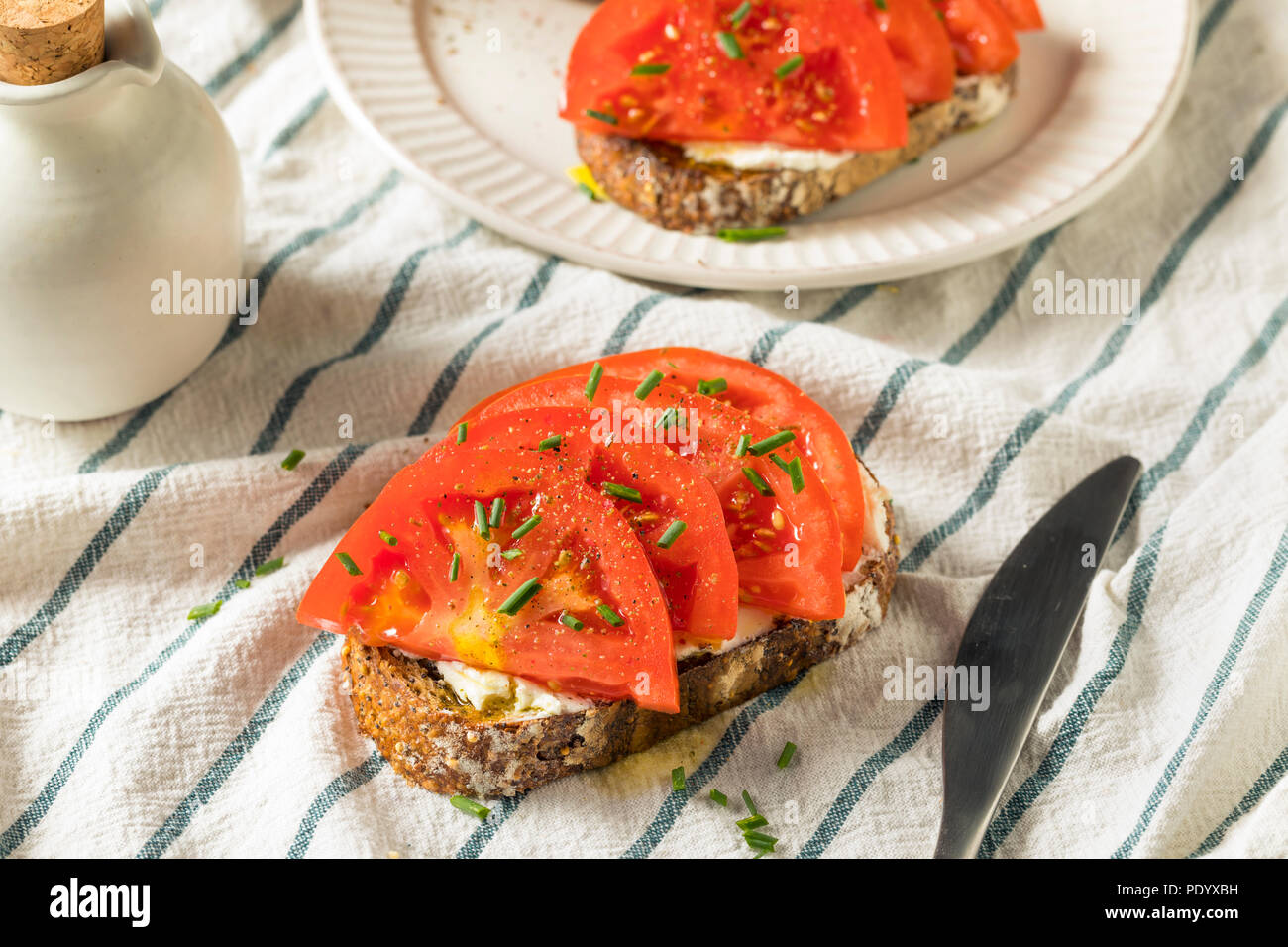 Trendy Homemade Tomato Toast with Goat Cheese and Chives Stock Photo ...