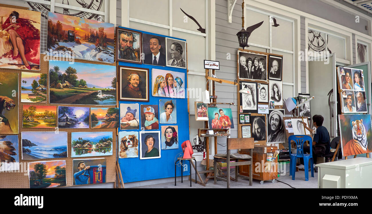 Artist studio. Artist at work in a studio with a vast array of his work ...
