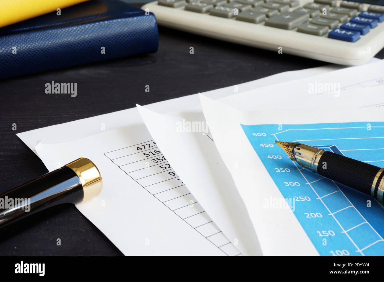 Accounting. Financial documents and charts on a desk Stock Photo - Alamy