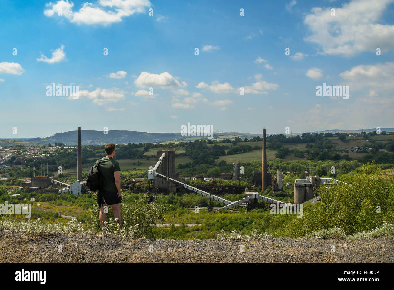 Person standing on a hillside overlooking the derelict building on the ...