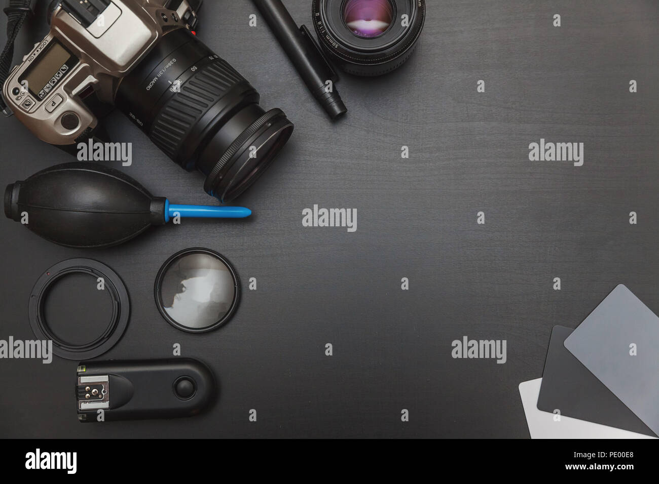 top view of work space photographer with dslr camera system, camera ...