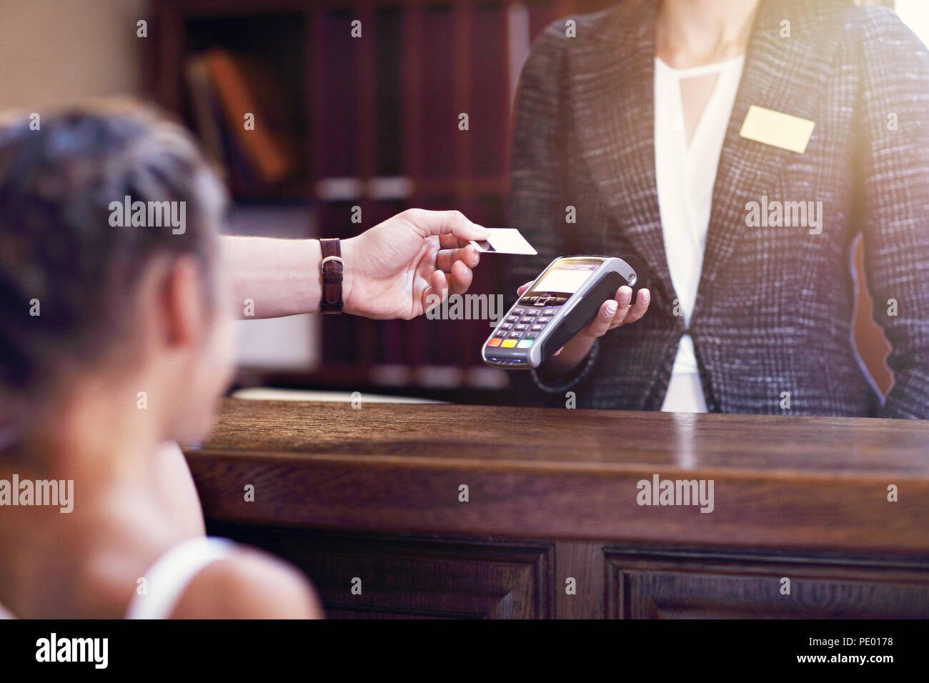 Happy family checking in hotel at reception desk Stock Photo - Alamy