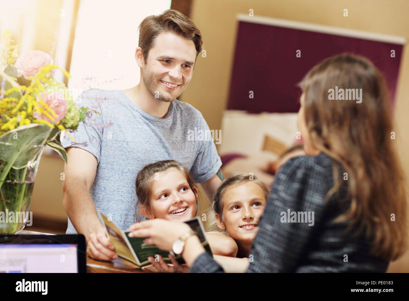 Family checking in hi-res stock photography and images - Alamy