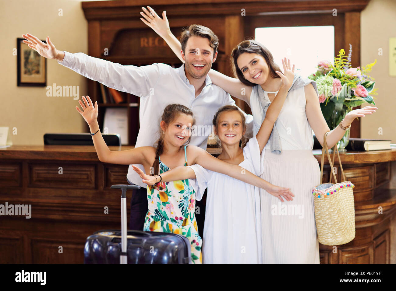 Family checking in hi-res stock photography and images - Alamy