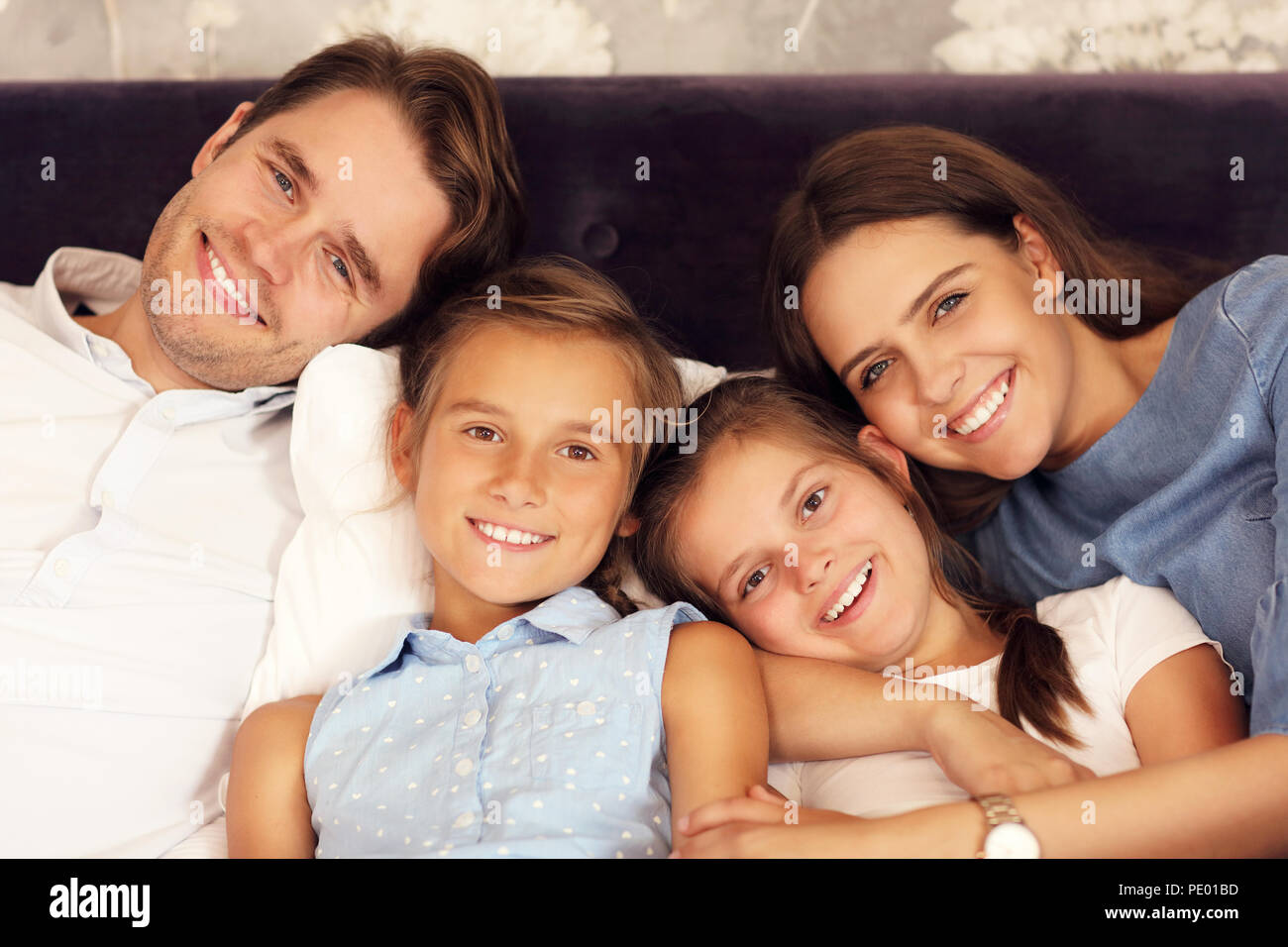 Happy family relaxing in hotel room Stock Photo - Alamy