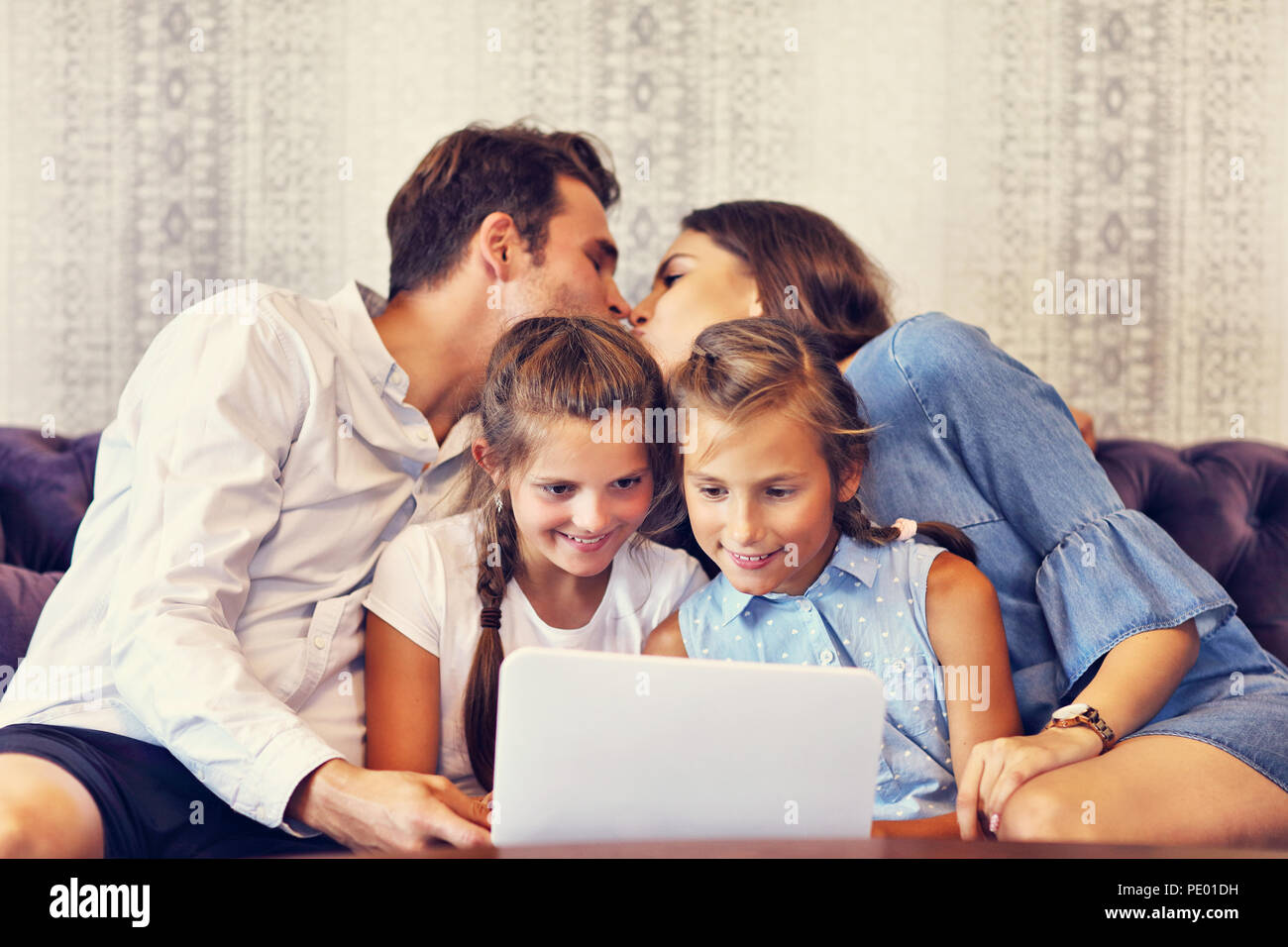 Happy family relaxing in hotel room Stock Photo - Alamy