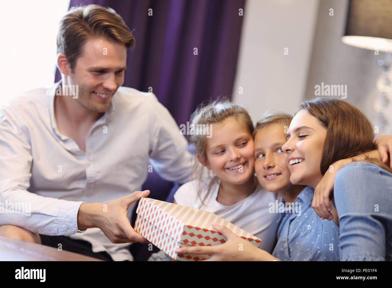 Happy family relaxing in hotel room Stock Photo - Alamy