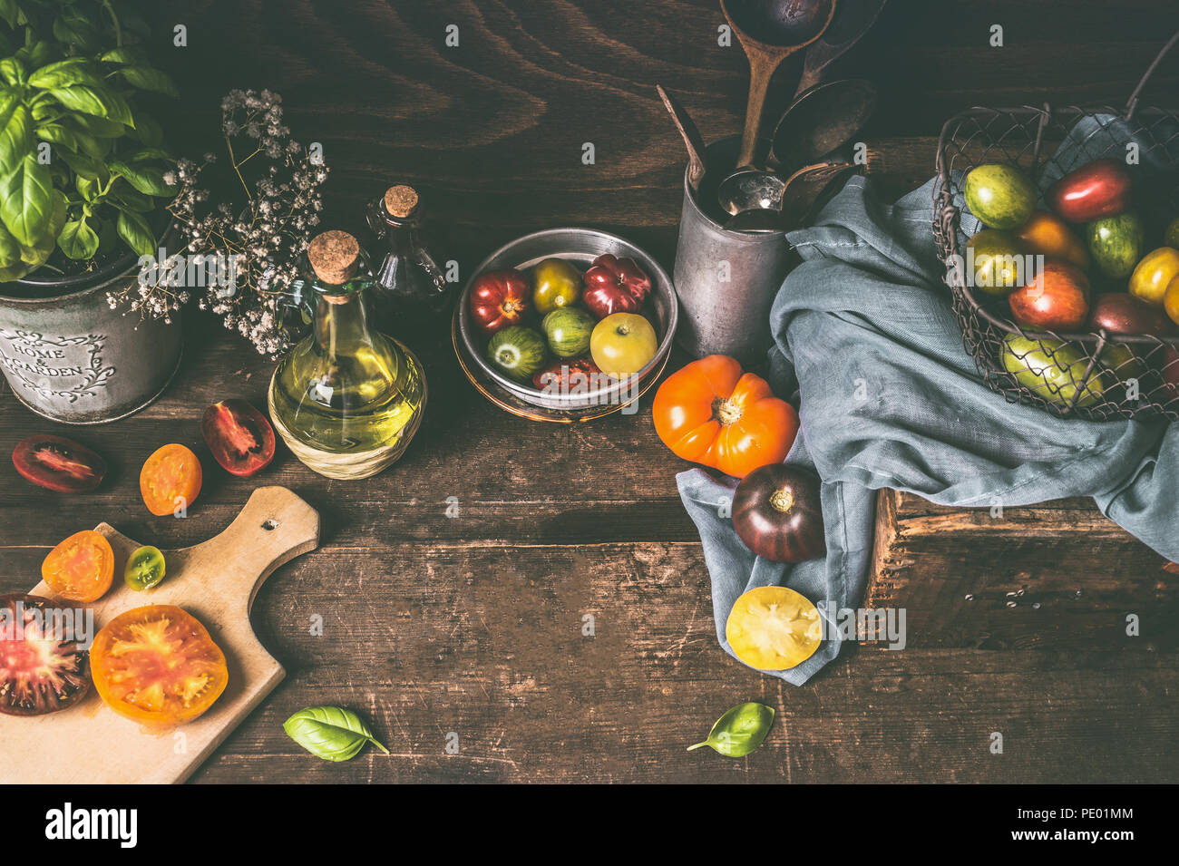 Dark rustic wooden kitchen table with colorful farm tomatoes ...