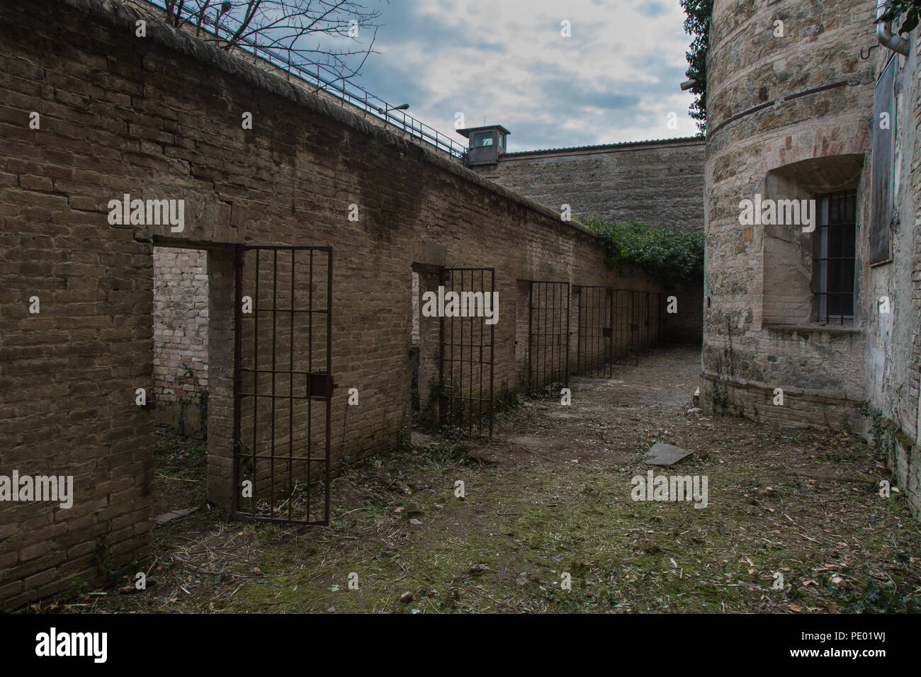 Unkempt Courtyard of an Old Prison Full of Weeds and Cells Stock Photo ...