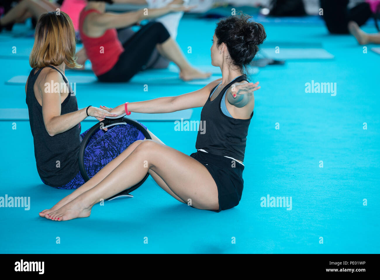Girls with Outstretched Arms doing Fitness Exercises on Mat at Gym ...