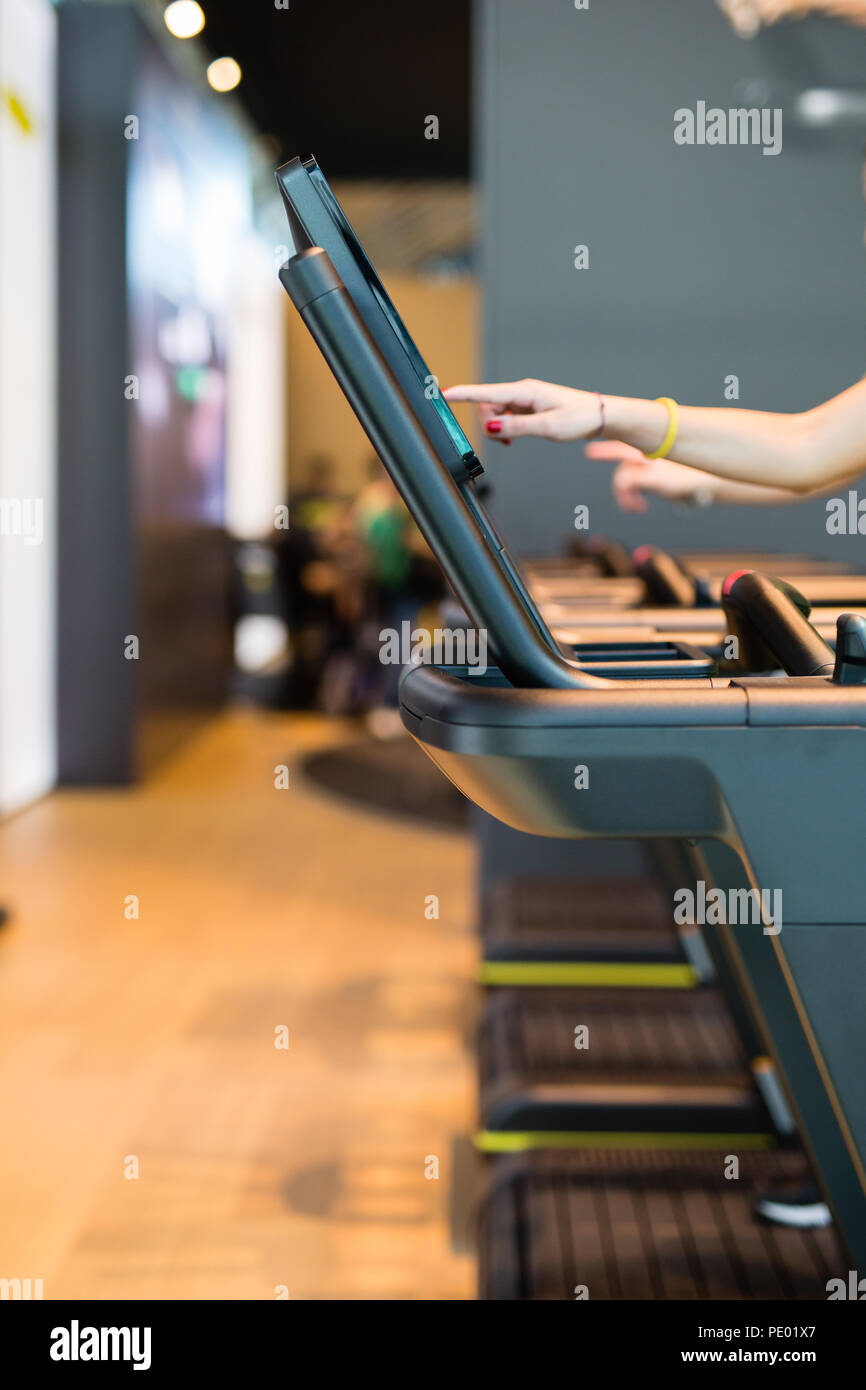 Detail of Fingers Touching a Touchscreen of Modern Running Machine in a ...