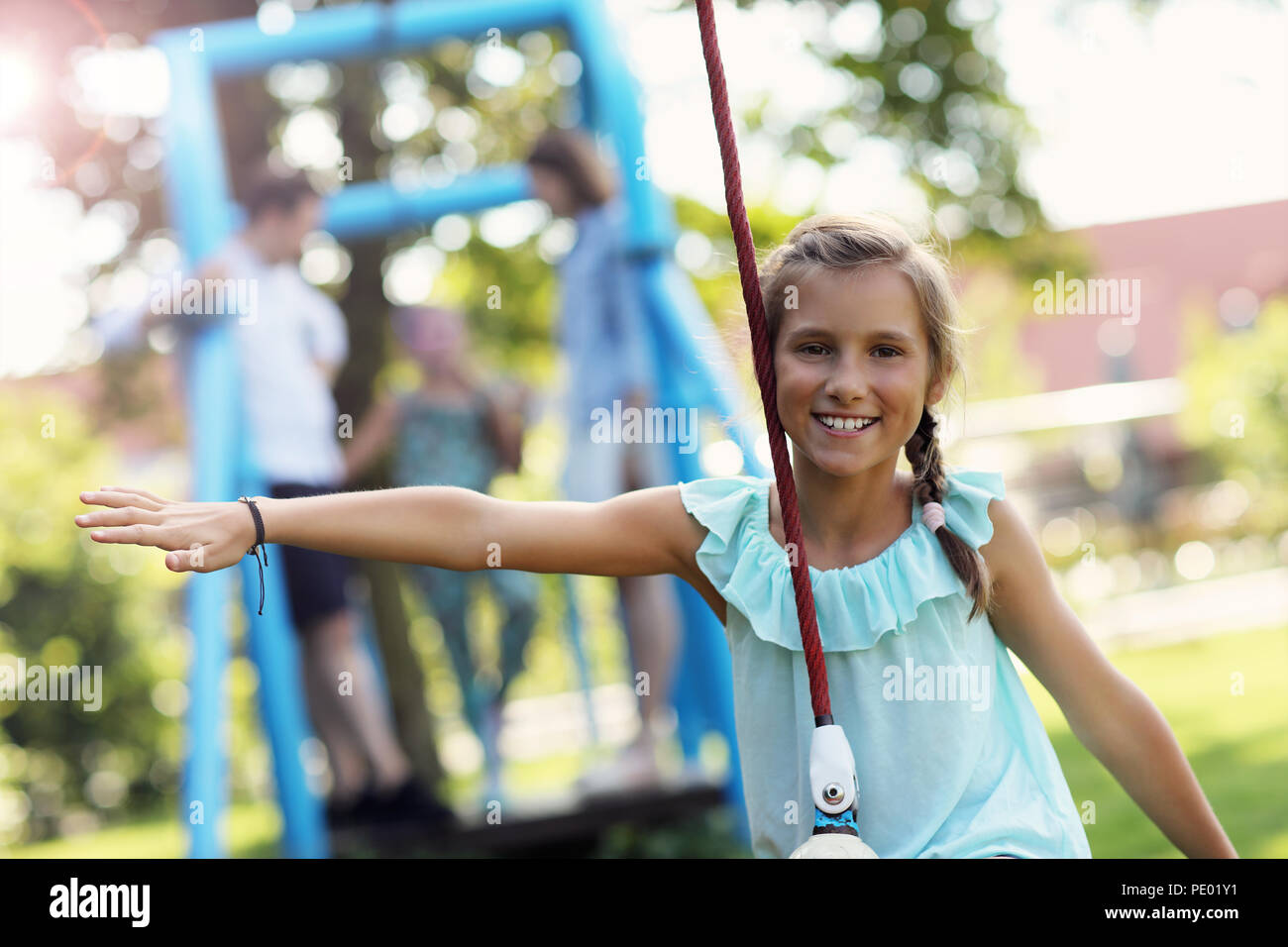 Joyful family having fun on playground Stock Photo - Alamy