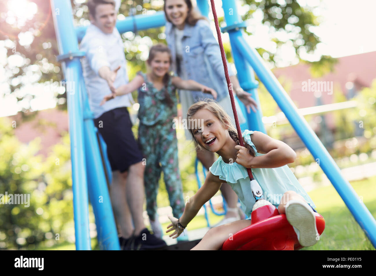 Joyful family having fun on playground Stock Photo - Alamy