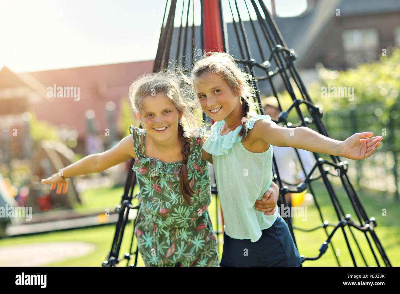 Joyful children having fun on playground Stock Photo - Alamy