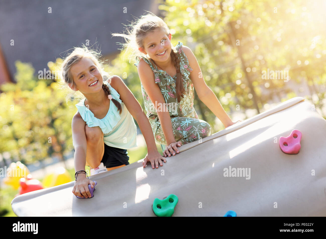 Joyful children having fun on playground Stock Photo - Alamy