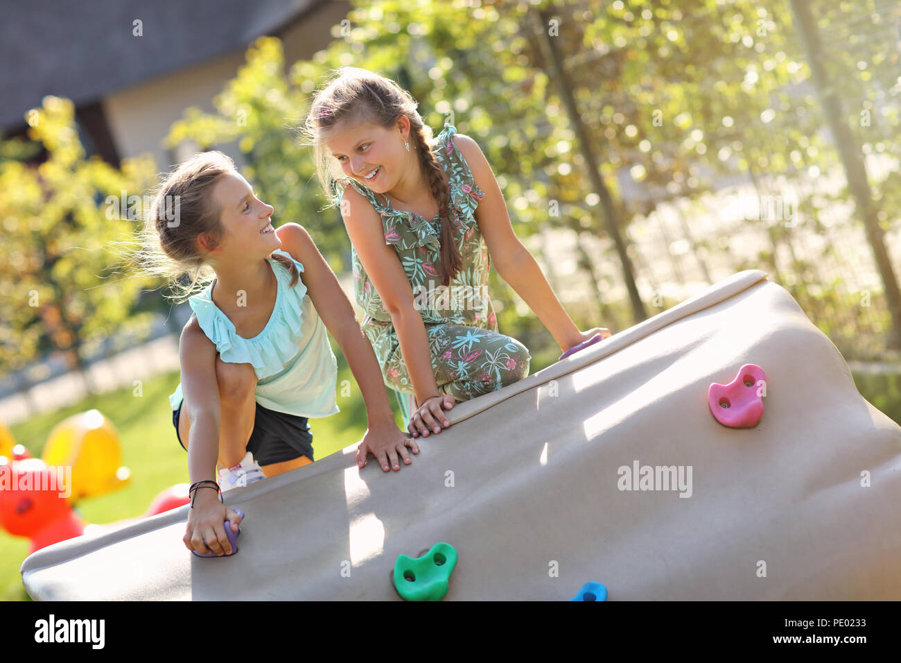 Joyful children having fun on playground Stock Photo - Alamy