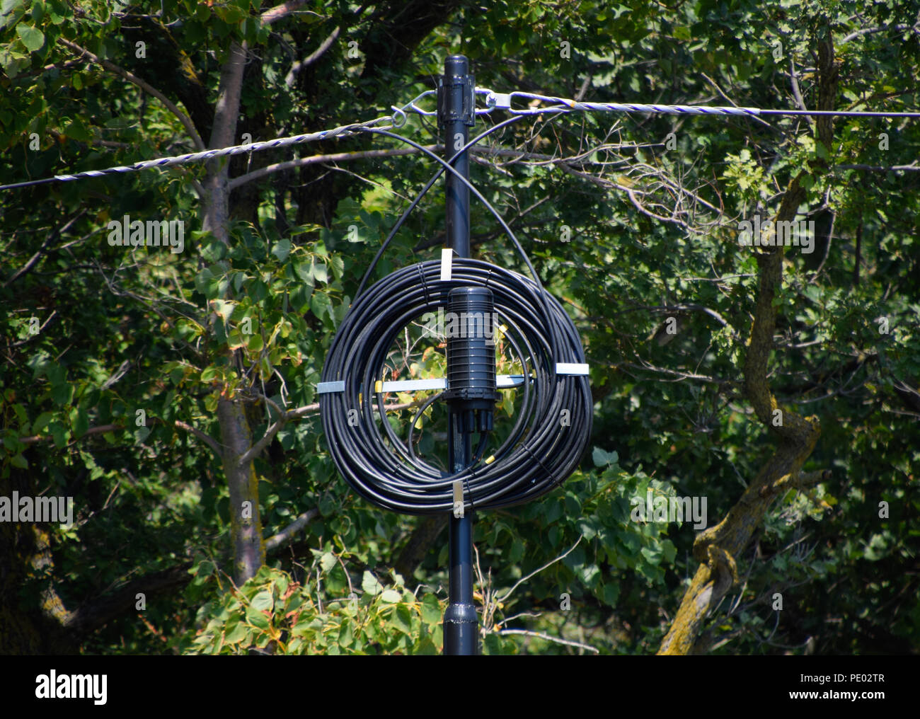 Power line post with a wound wire. The new wire is on the pole Stock ...