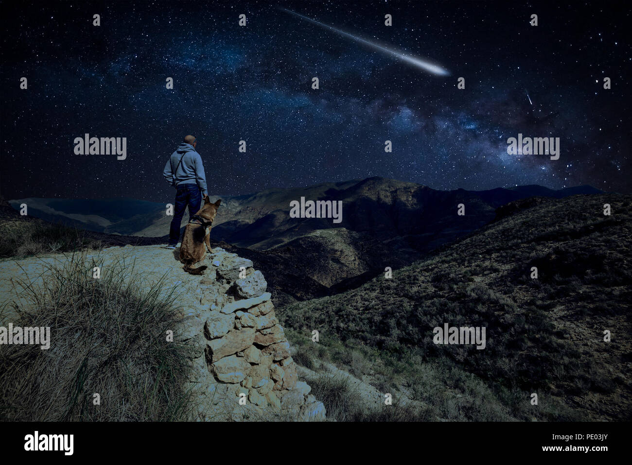 Man with dog observe Perseid Meteor Shower and the Milky Way outdoor ...