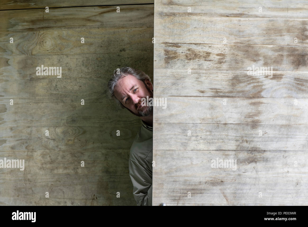 A pale man with a serious expression surrounded by neutral tones Stock ...