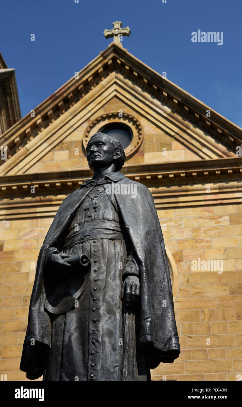 A bronze statue of Archbishop Jean Lamy stands in front of the ...