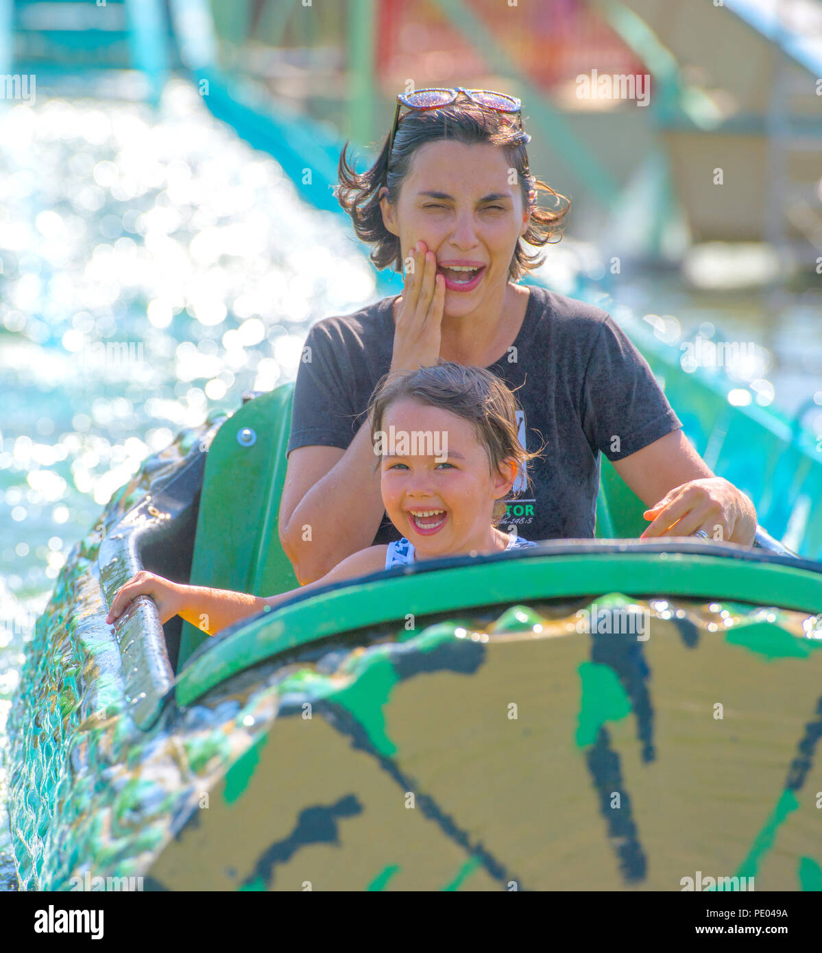Mother daughter enjoy water slide hi-res stock photography and images ...