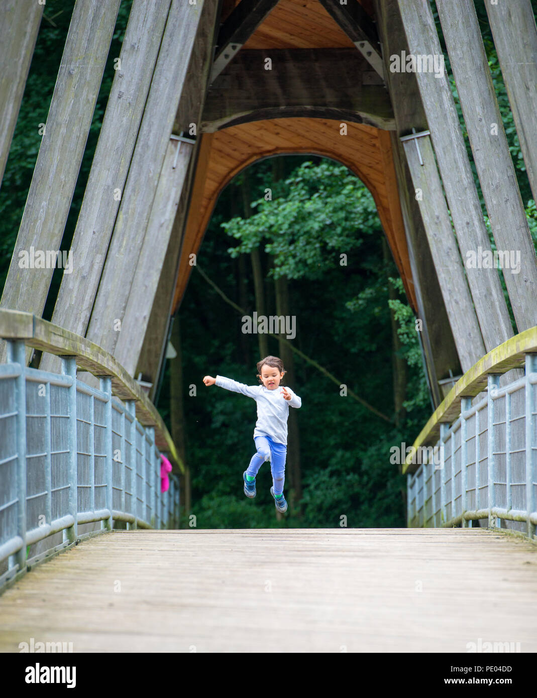Little child having fun by running and jumping Stock Photo - Alamy
